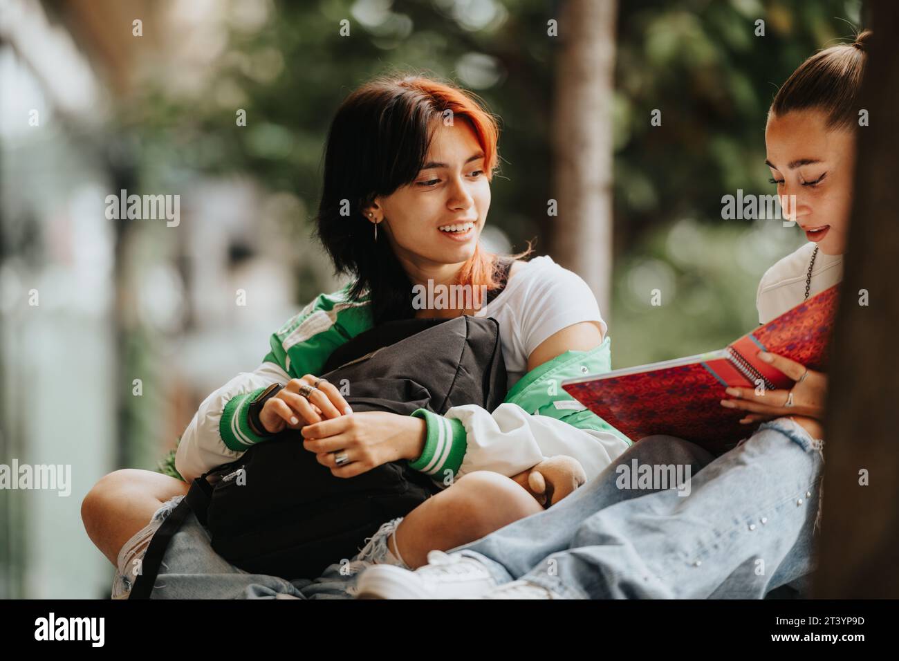 Two Girls Studying Outdoors and Helping Each Other with Homework After ...