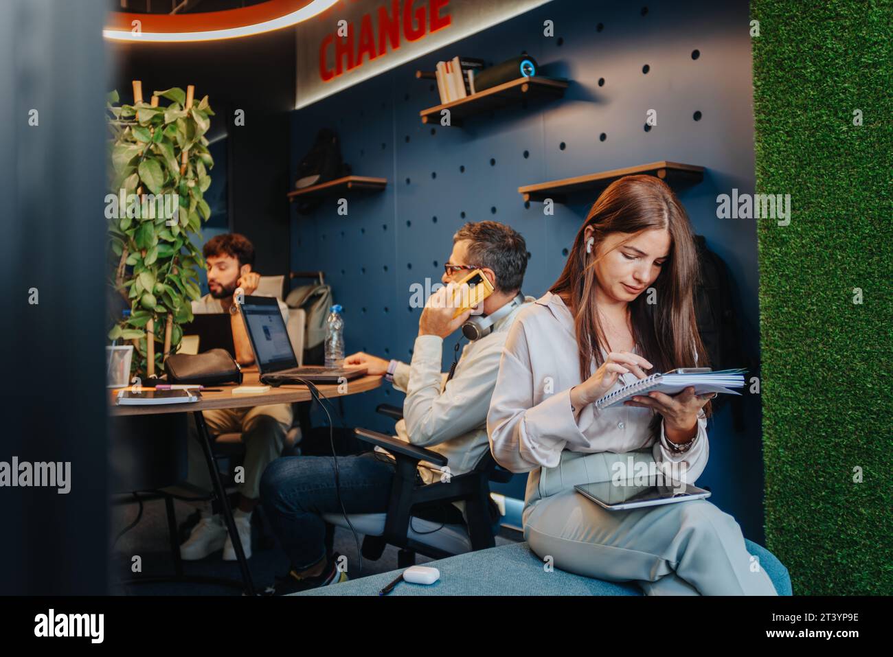 Group of professionals collaborates in a co-working space. They work on ...