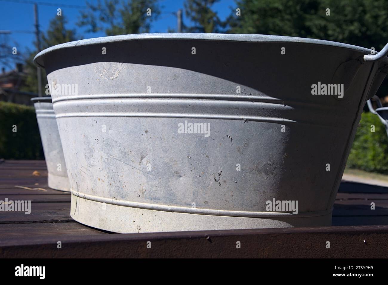 Tin buckets on a carriage in a garden Stock Photo - Alamy