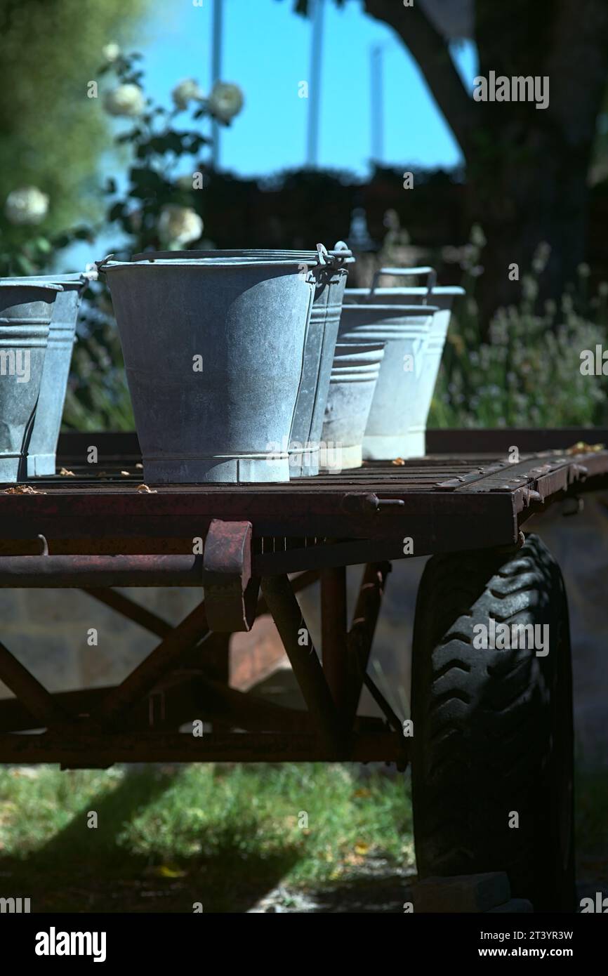 Tin buckets on a carriage in a garden Stock Photo - Alamy