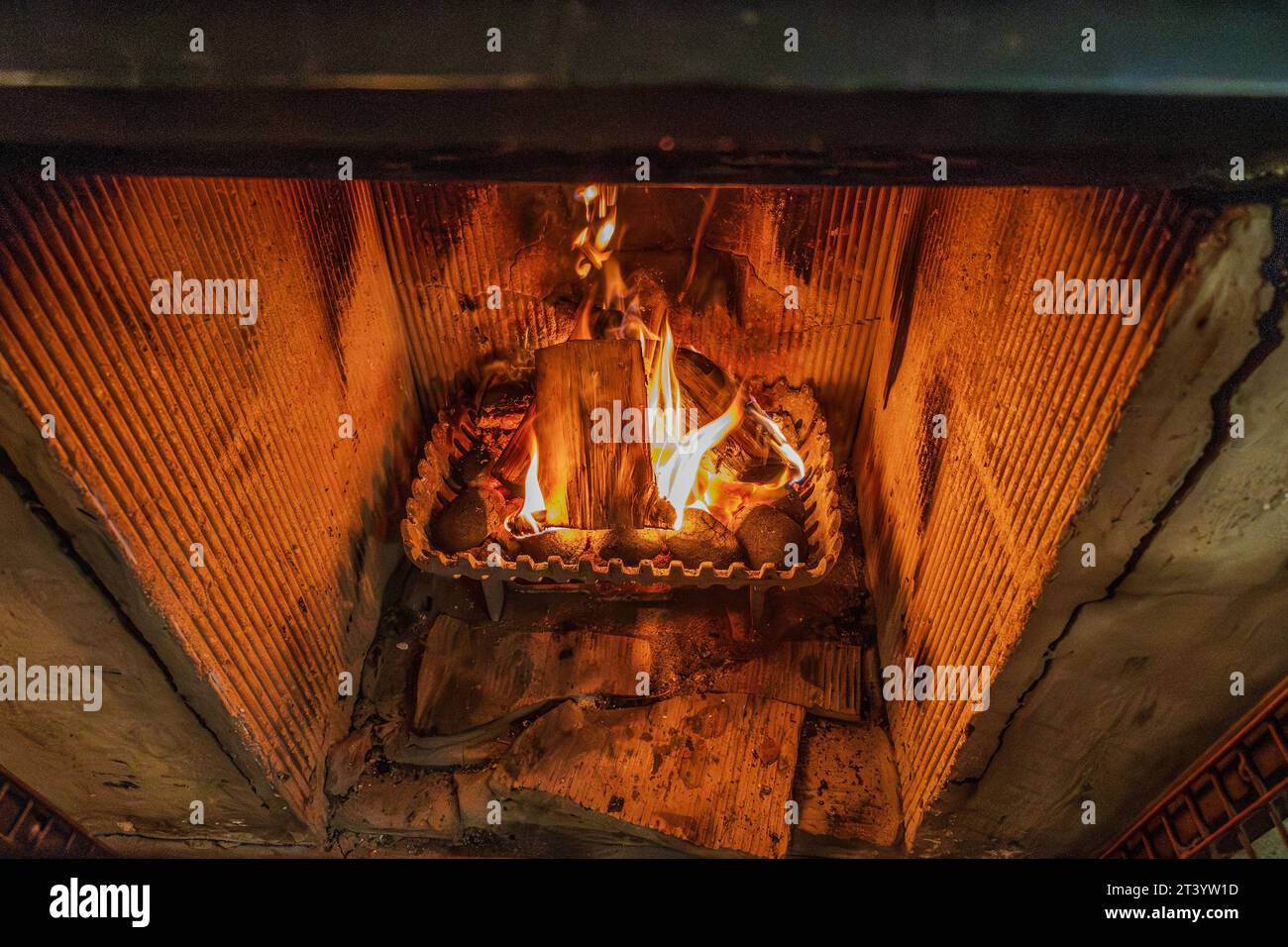 A roaring real fire in the grate fuelled by logs of wood Stock Photo ...