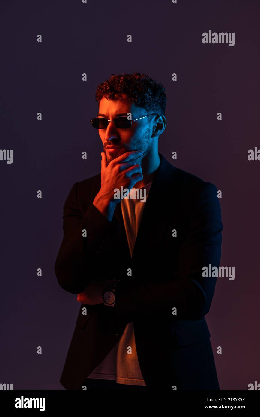 Portrait of attractive serious successful guy wearing specs looking far ...