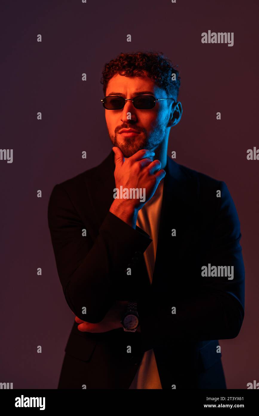 Portrait of attractive serious successful guy wearing specs looking far ...