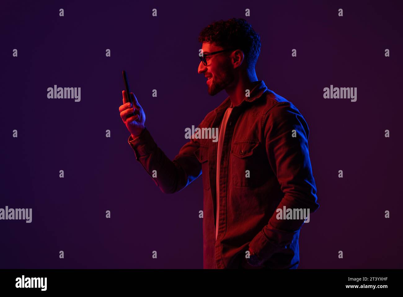 Hand in neon light typing hi-res stock photography and images - Alamy