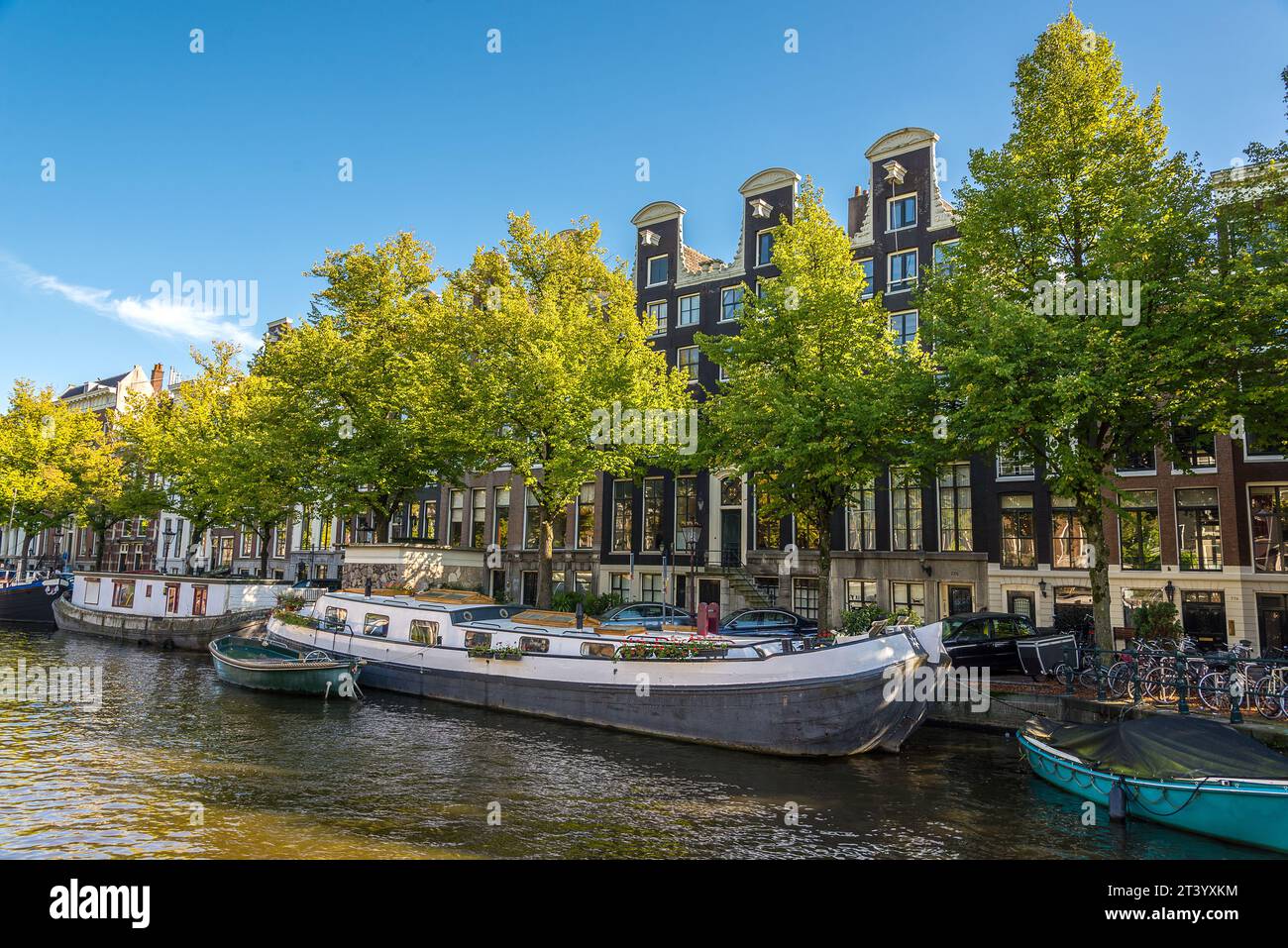 Traditional Amsterdam canal with boats houseboats and bridges Stock ...