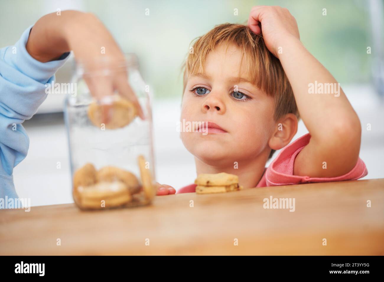 Child reaching for biscuit hi-res stock photography and images - Alamy