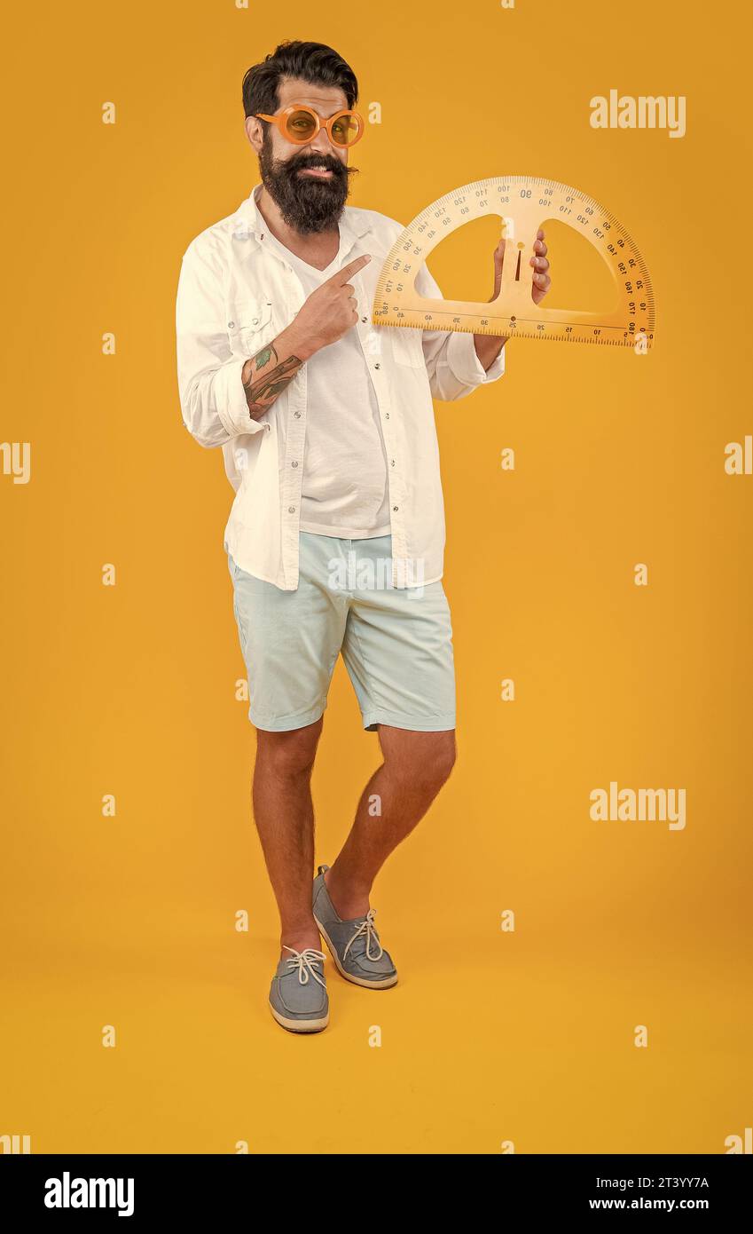 man hold geometry protractor on background, point finger. photo of man ...