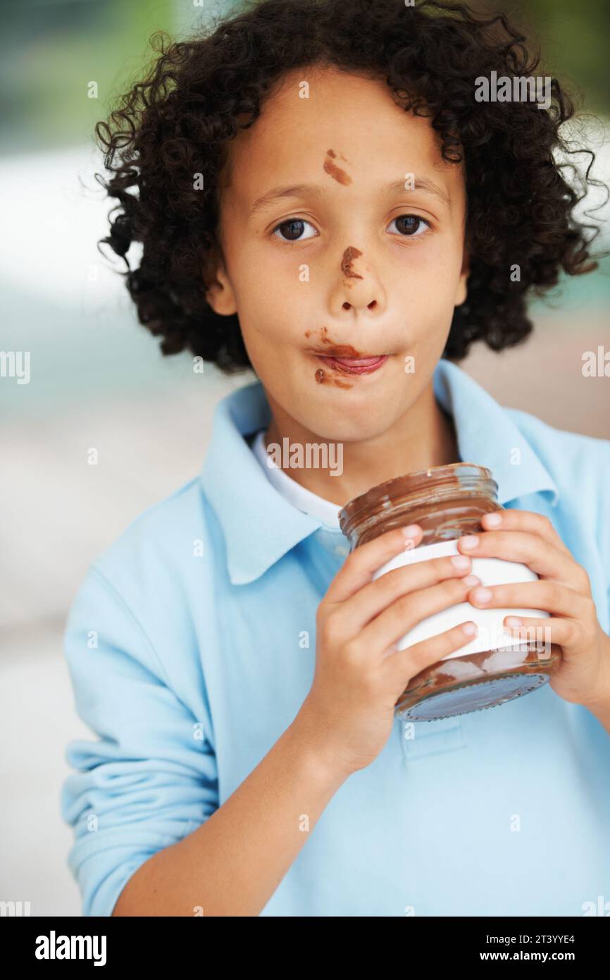 Cute, portrait and child with chocolate spread at a home with delicious ...