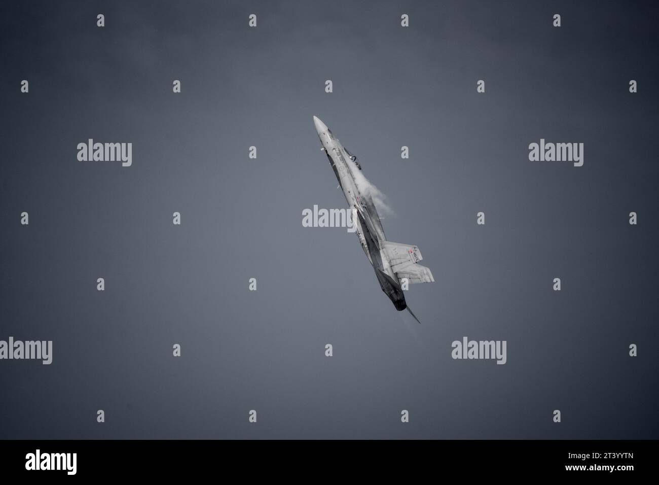 This image features a fighter jet soaring through the sky, its wings ...