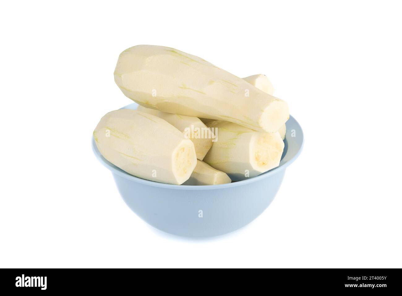 Peeled zucchini in a blue bowl on a white background. Copy space Stock ...