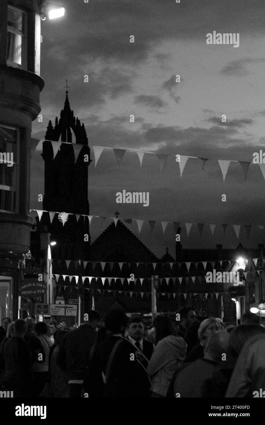Greyscale portrait photo of Church tower and banners during Celtic ...