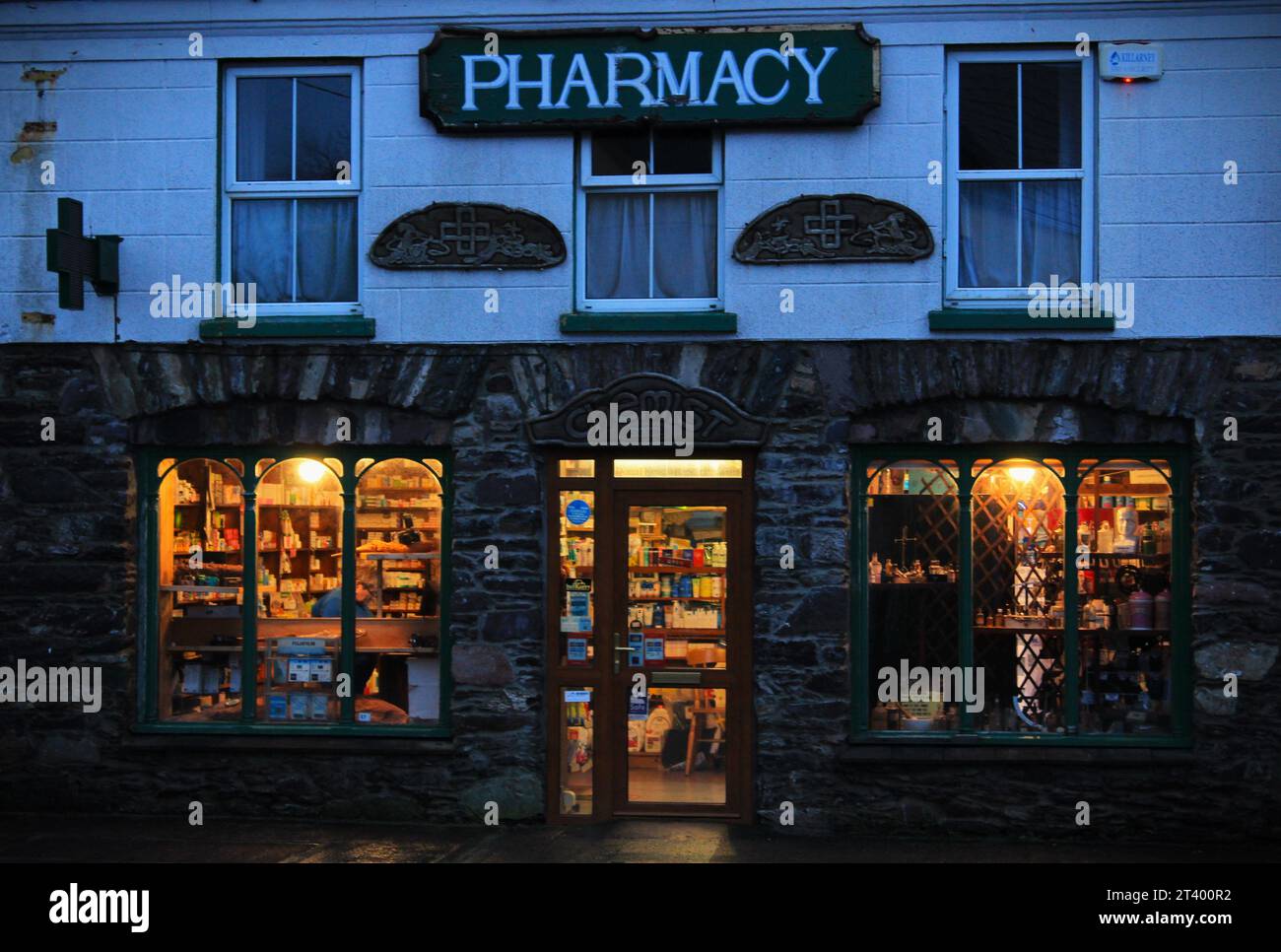Sneem Pharmacy seen at dusk in Sneem, along the Ring of Kerry. Evening ...