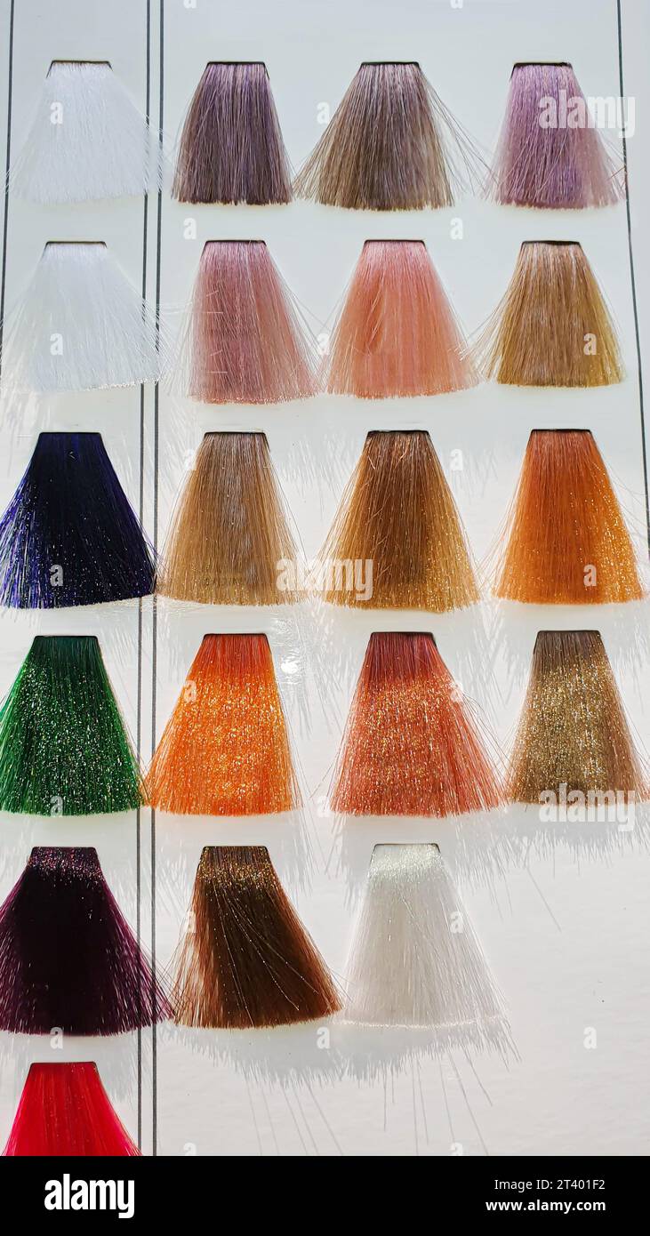 A palette of hair colors made from artificial strands on a white ...