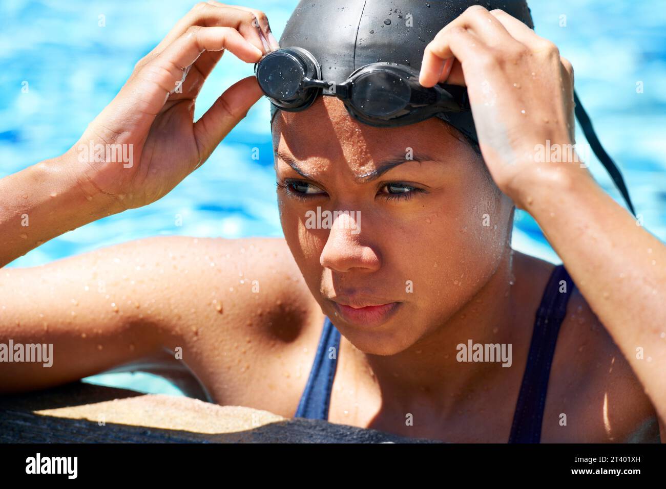 Serious, face and woman swimming with goggles for challenge, underwater ...