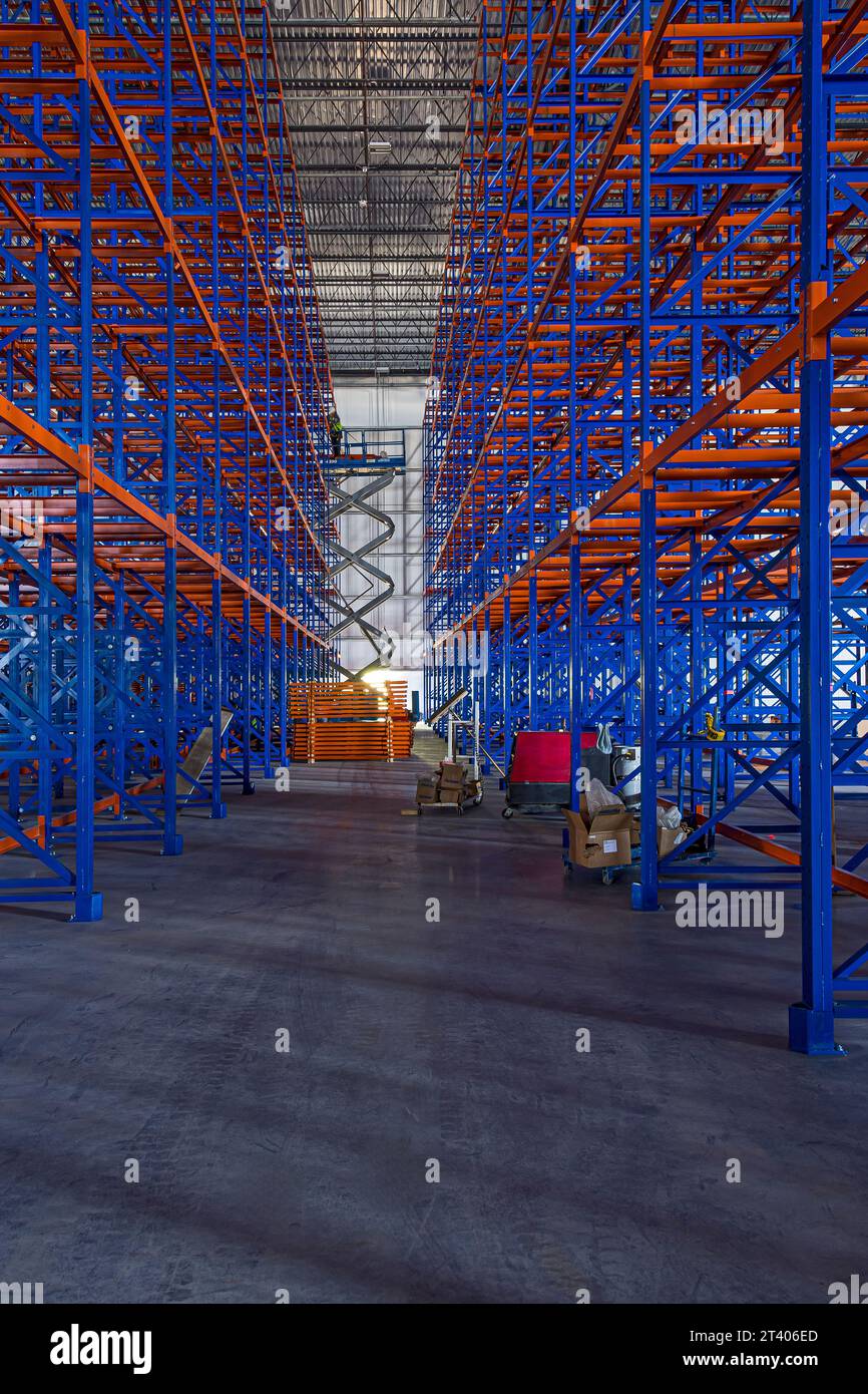 Aisle between shelving with materials, and a scissors-lift at a new ...