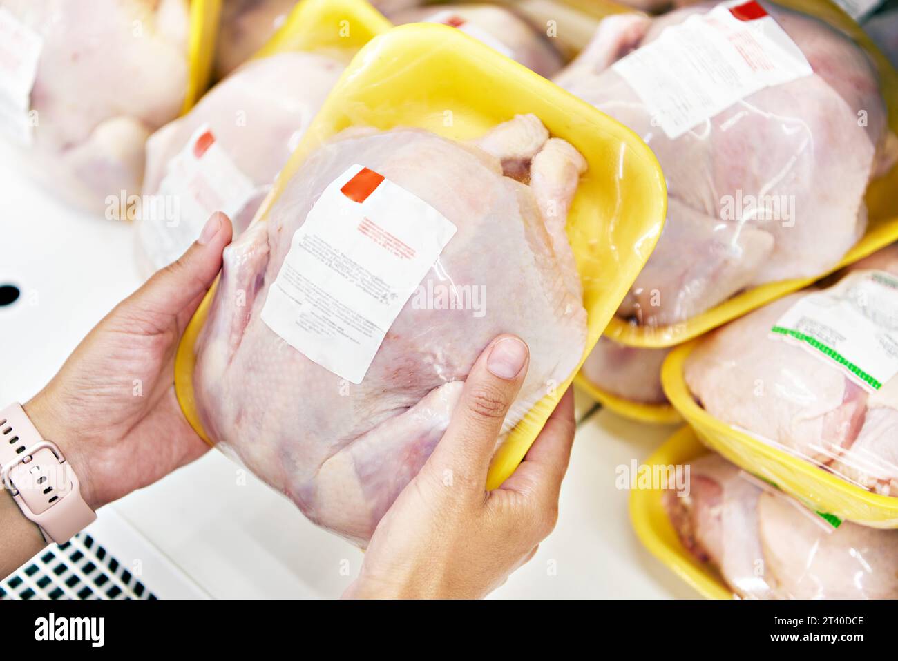 Human hands with chicken meat in the store Stock Photo - Alamy