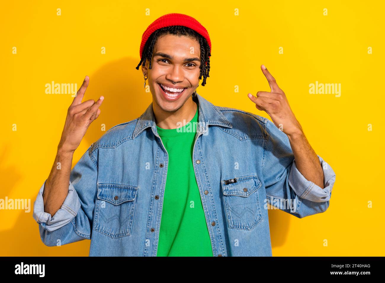 Photo of funky cool guy dressed denim jacket beanie showing two hard ...