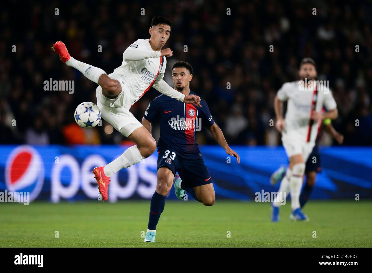 Tijjani Reijnders of AC Milan competes for the ball with Warren Zaire ...