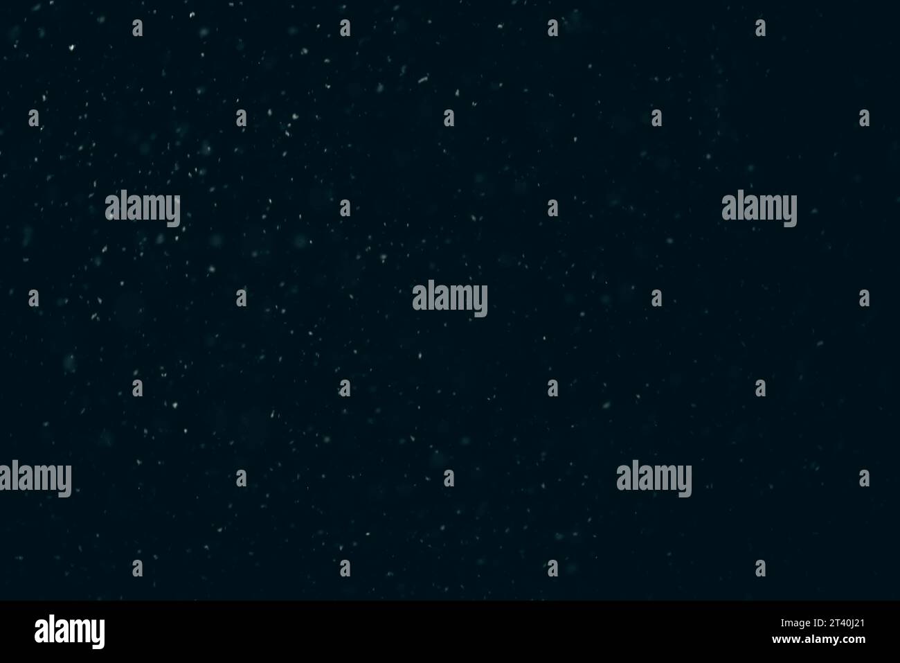 Close up white snow falling over black background of night winter sky ...