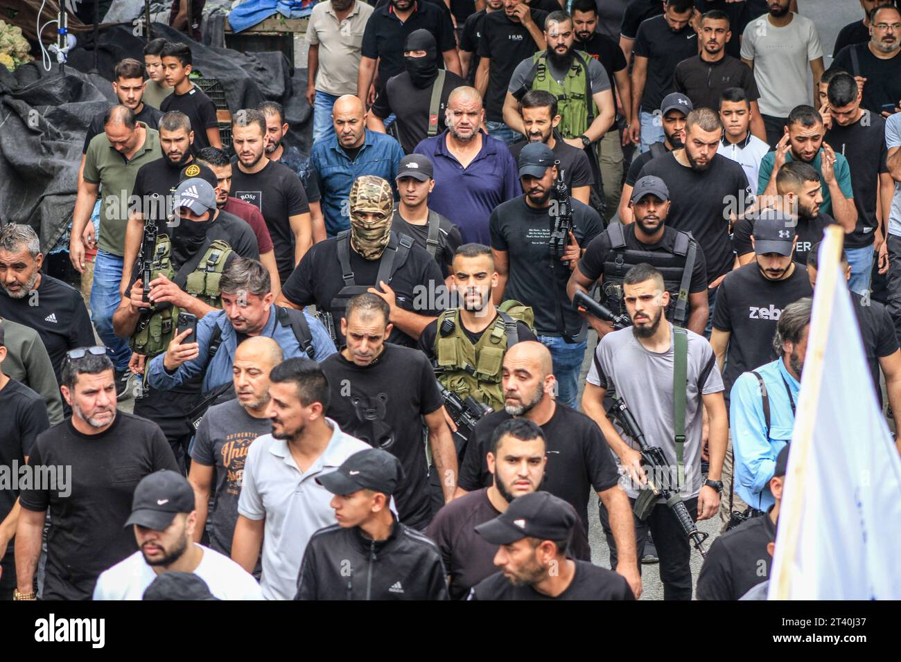Palestinian gunmen attend the funeral of Aysar al-Amer, 25, a local ...