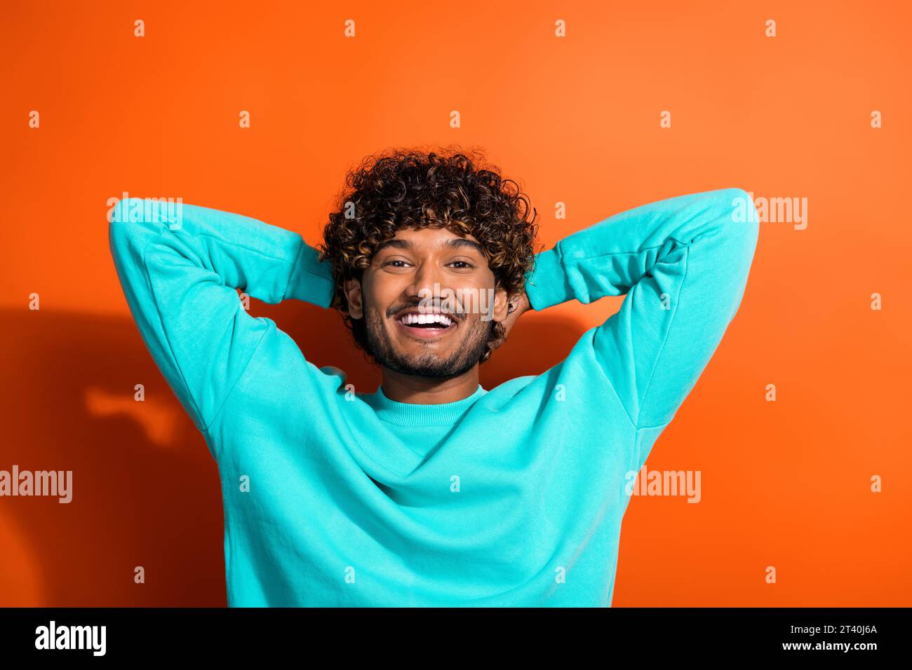 Photo of cheerful peaceful young man beaming smile good mood arms ...
