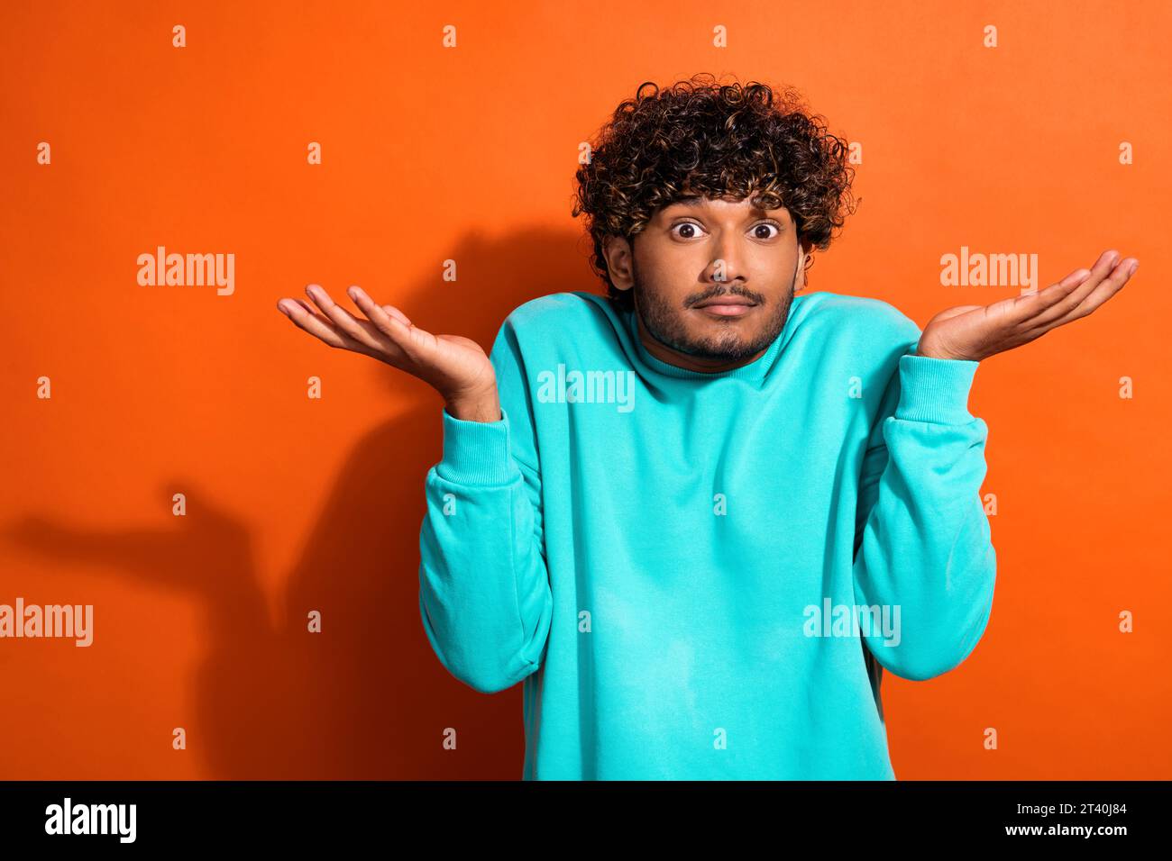 Photo of clueless questioned person raise arms shrug shoulders empty ...