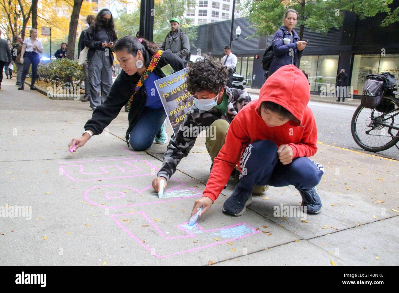 A mother and her children write messages in chalk at the Boot Boeing ...
