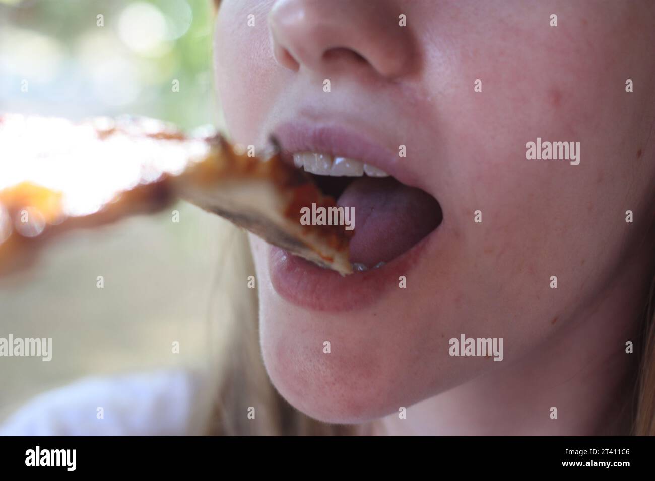 Closse up of girl mouth eating food Stock Photo - Alamy