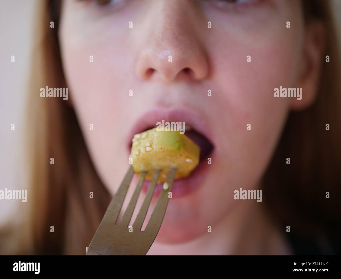 Closse up of girl mouth eating food Stock Photo - Alamy