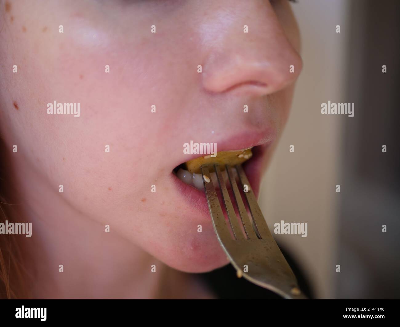 Closse up of girl mouth eating food Stock Photo - Alamy