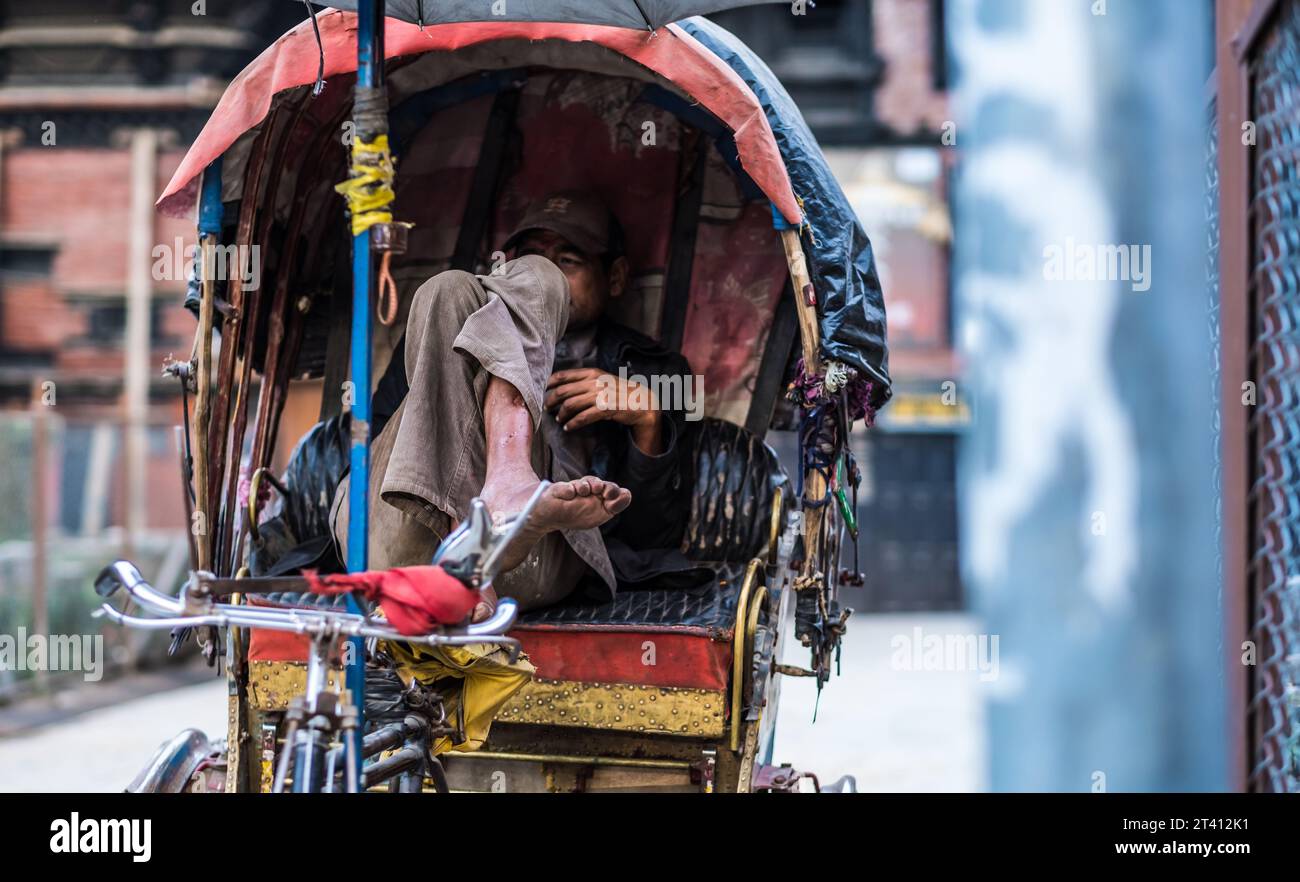 Kathmandu, Nepal - 06 October 2017: Middle-aged rickshaw driver sits ...