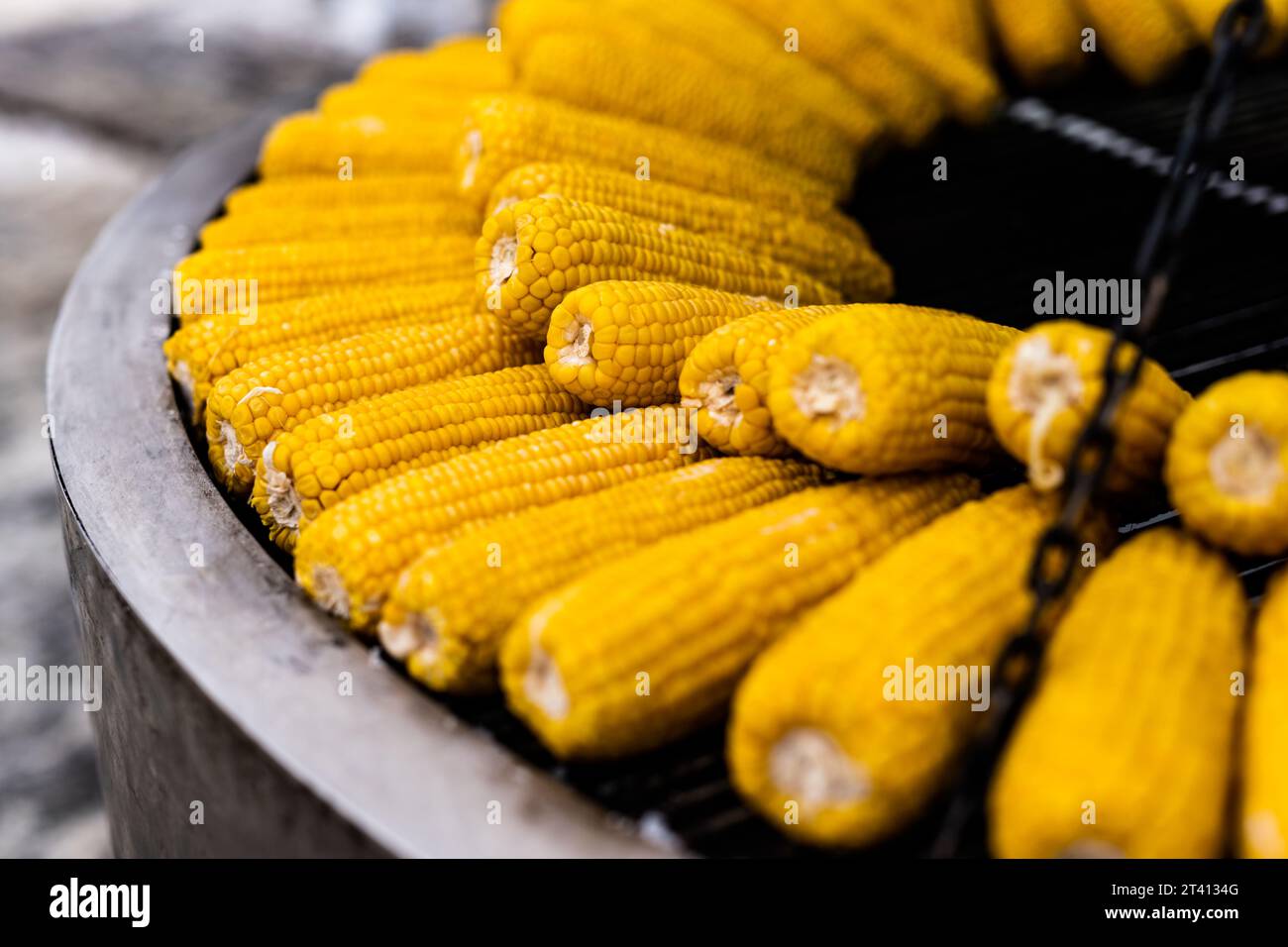 Boiled corn at street food market closeup. Fresh yellow vegetable maize ...