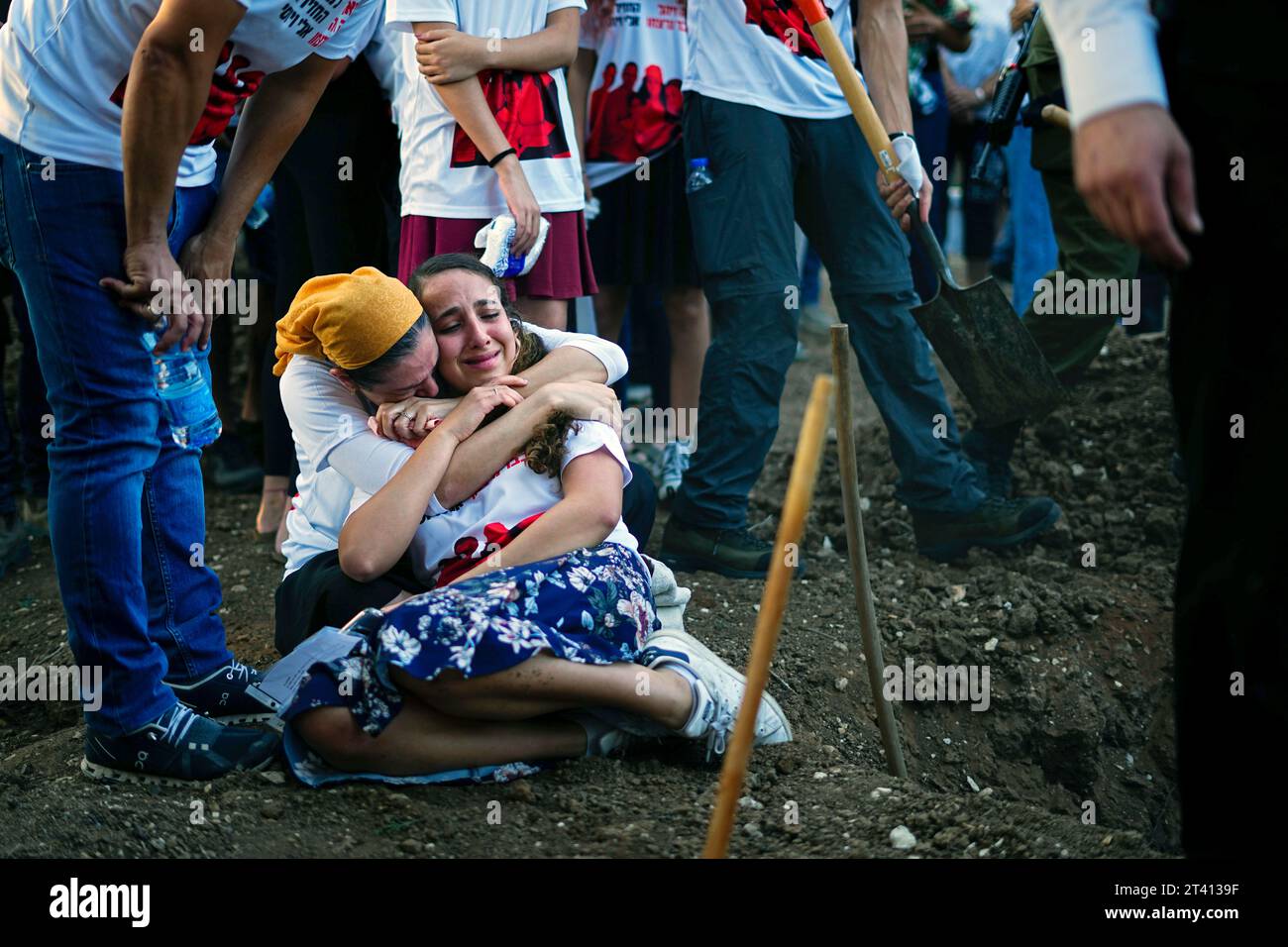 Mourners gather around the graves of British-Israelis Lianne Sharabi ...