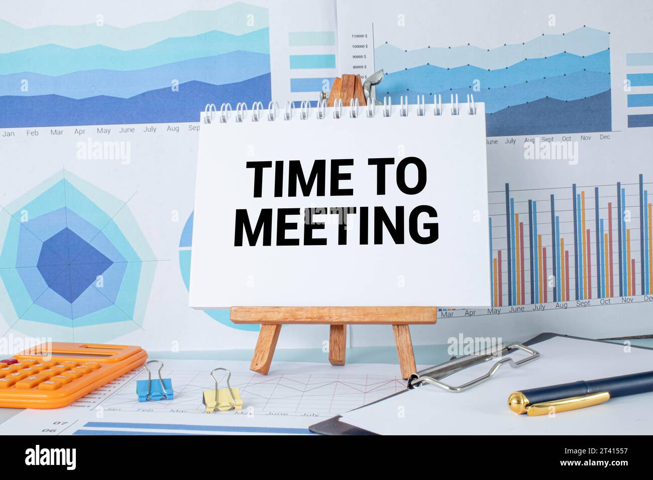 TIME TO MEETING text written on a paper clipboard with office tools ...