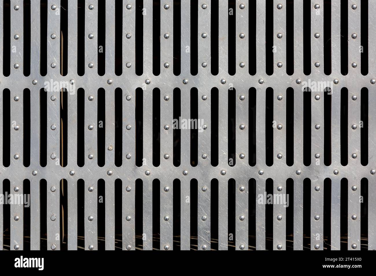 iron drainage grate with stripes, industrial object design, close-up ...