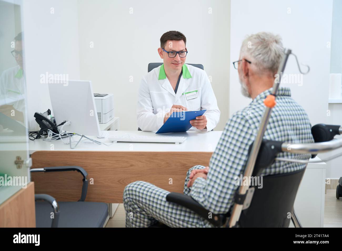 Doctor conducts a survey of a patient in his office Stock Photo - Alamy