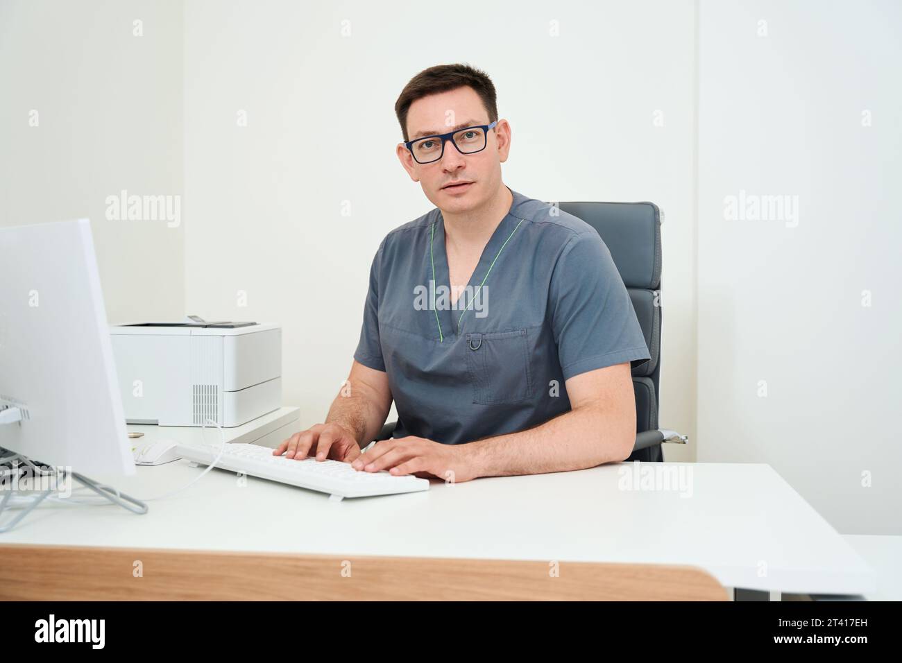Caucasian doctor sits desk works hi-res stock photography and images ...