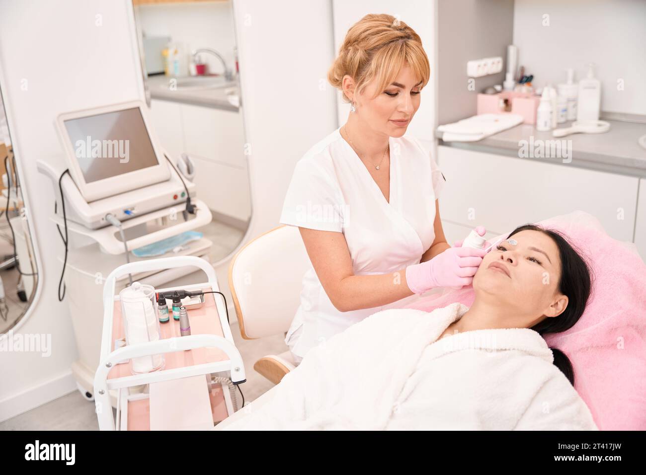 Beauty master applies cream to woman eyebrows Stock Photo - Alamy
