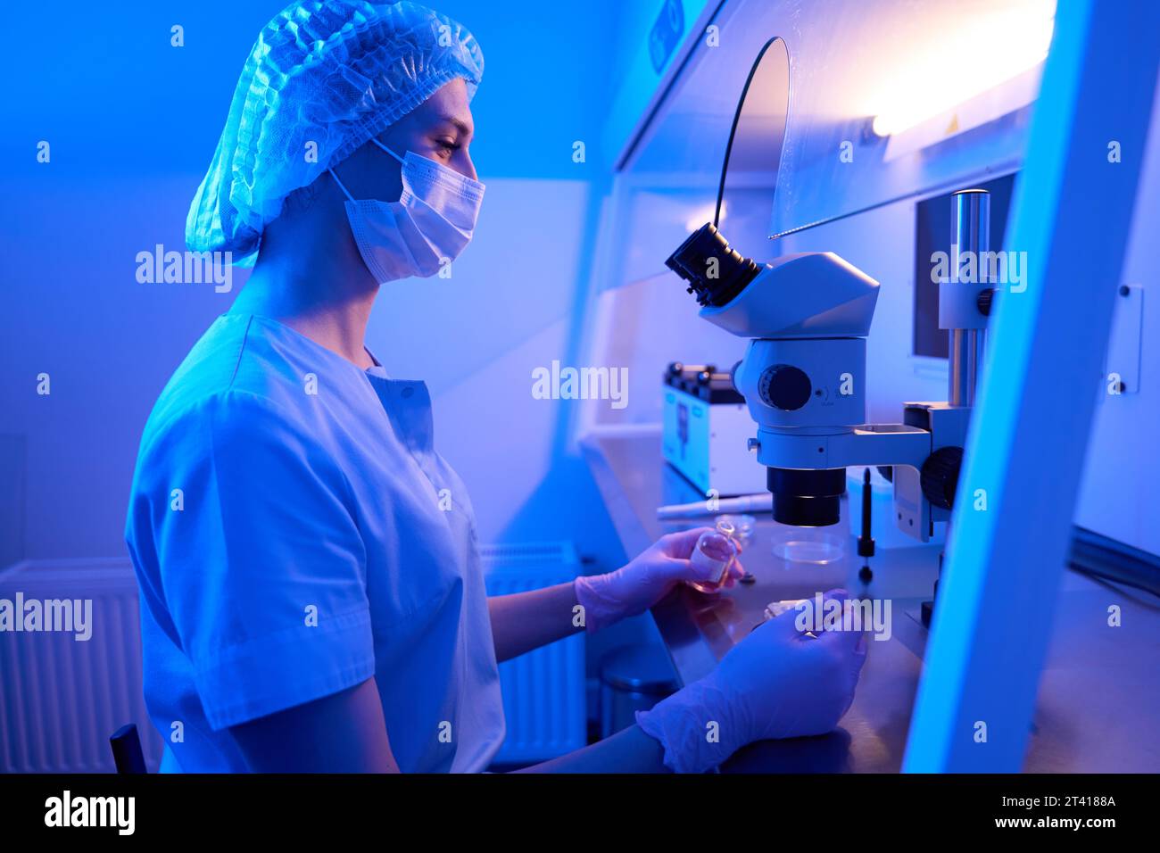 Focused woman scientist working microscope hi-res stock photography and ...