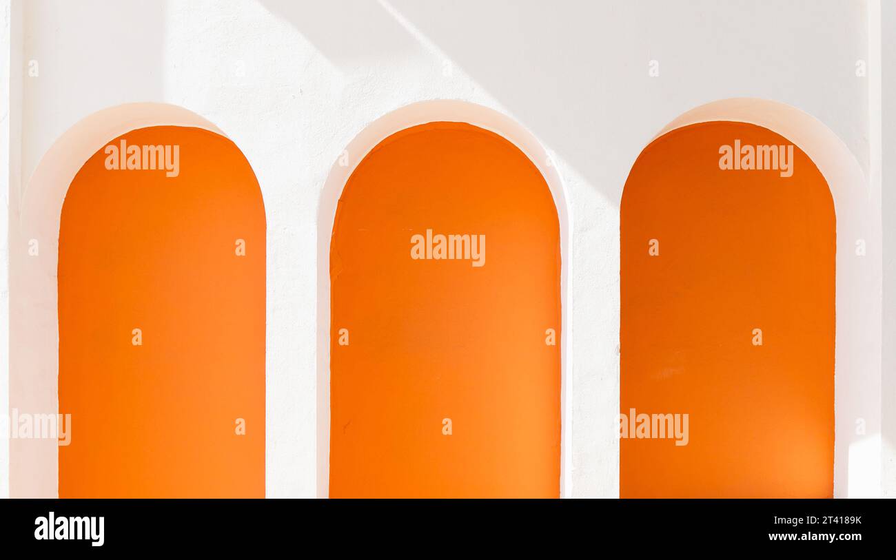 Three white and orange arches, architectural detail in Marbella city ...