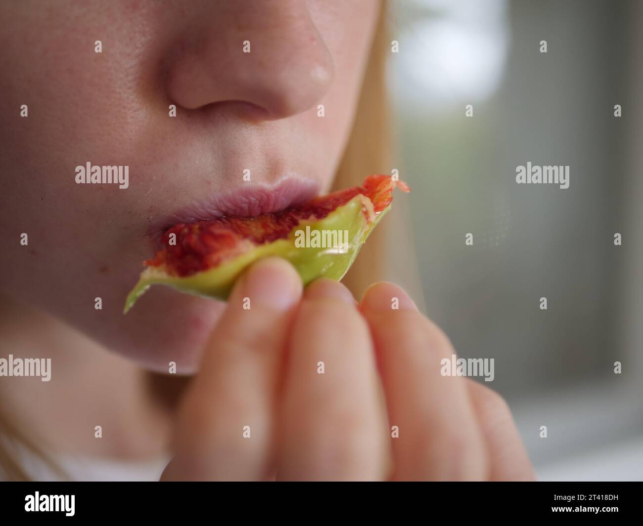 Closse up of girl mouth eating food Stock Photo - Alamy