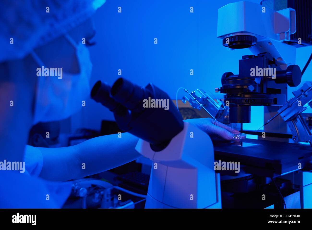 Embryologist preparing for conducting ICSI procedure with ...