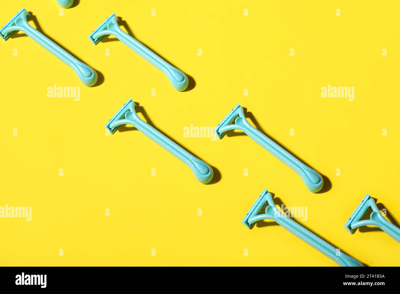 Many safety razors on yellow background Stock Photo - Alamy
