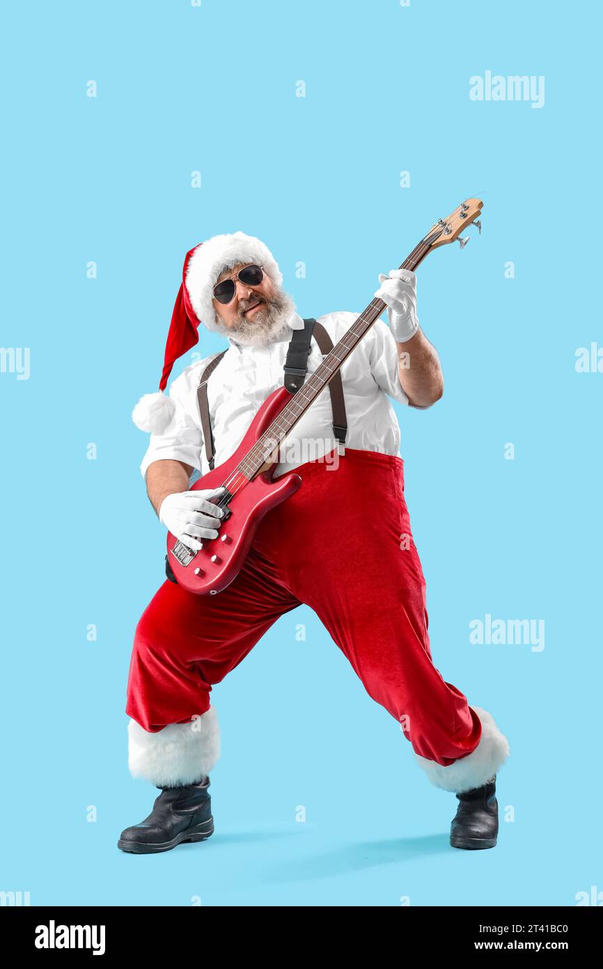 Cool Santa Claus playing guitar on blue background Stock Photo - Alamy