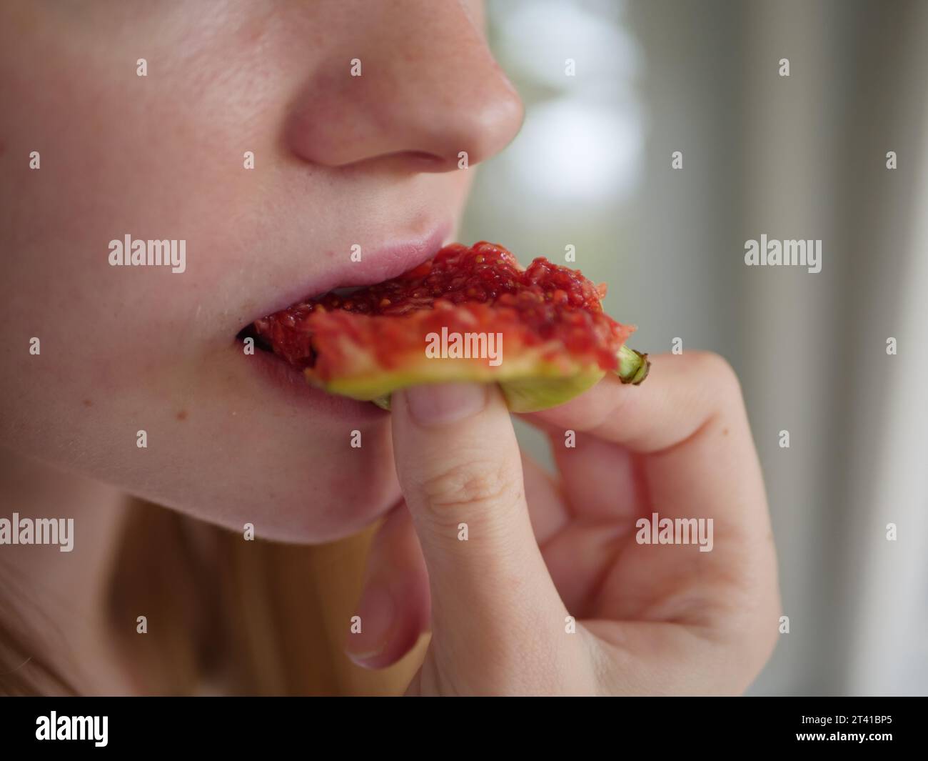 Closse up of girl mouth eating food Stock Photo - Alamy