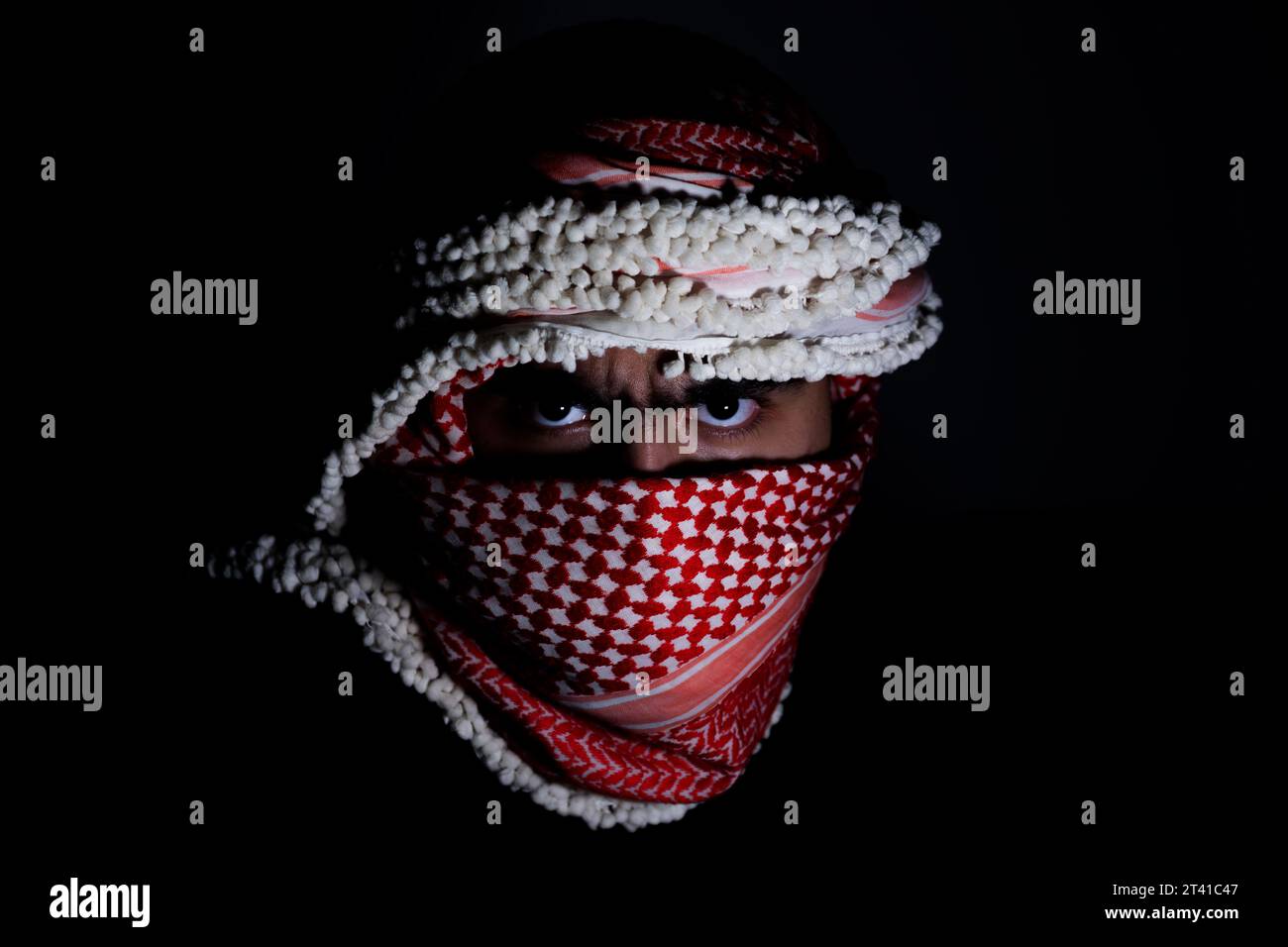 portrait of pearson wearing red keffiyeh on dark background with anger ...