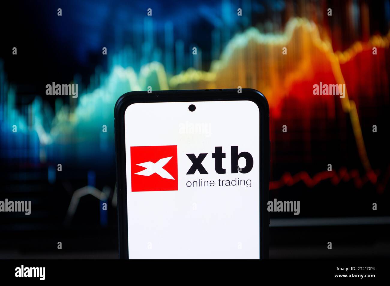 In this photo illustration a Xtb Online Trading logo seen displayed on ...