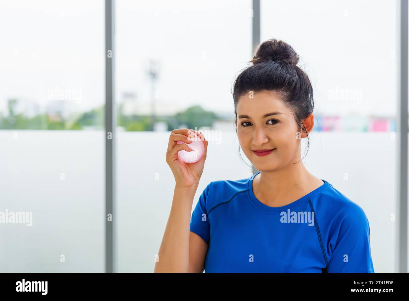woman in sportswear holding the rubber ball hand grip exercise Stock ...