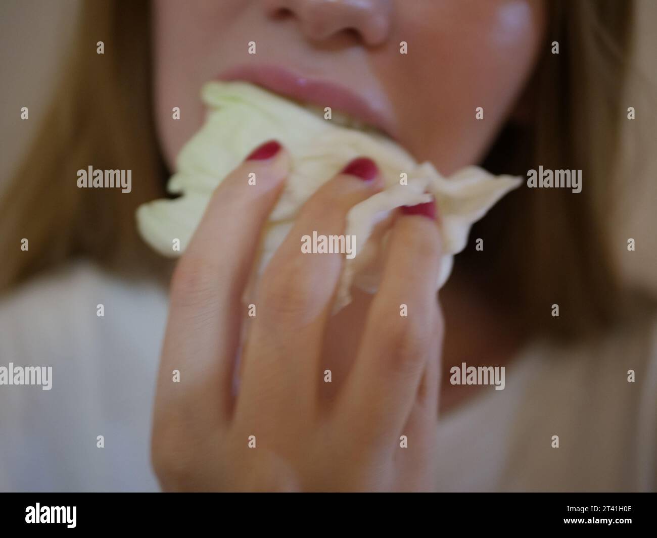 Closse up of girl mouth eating food Stock Photo - Alamy
