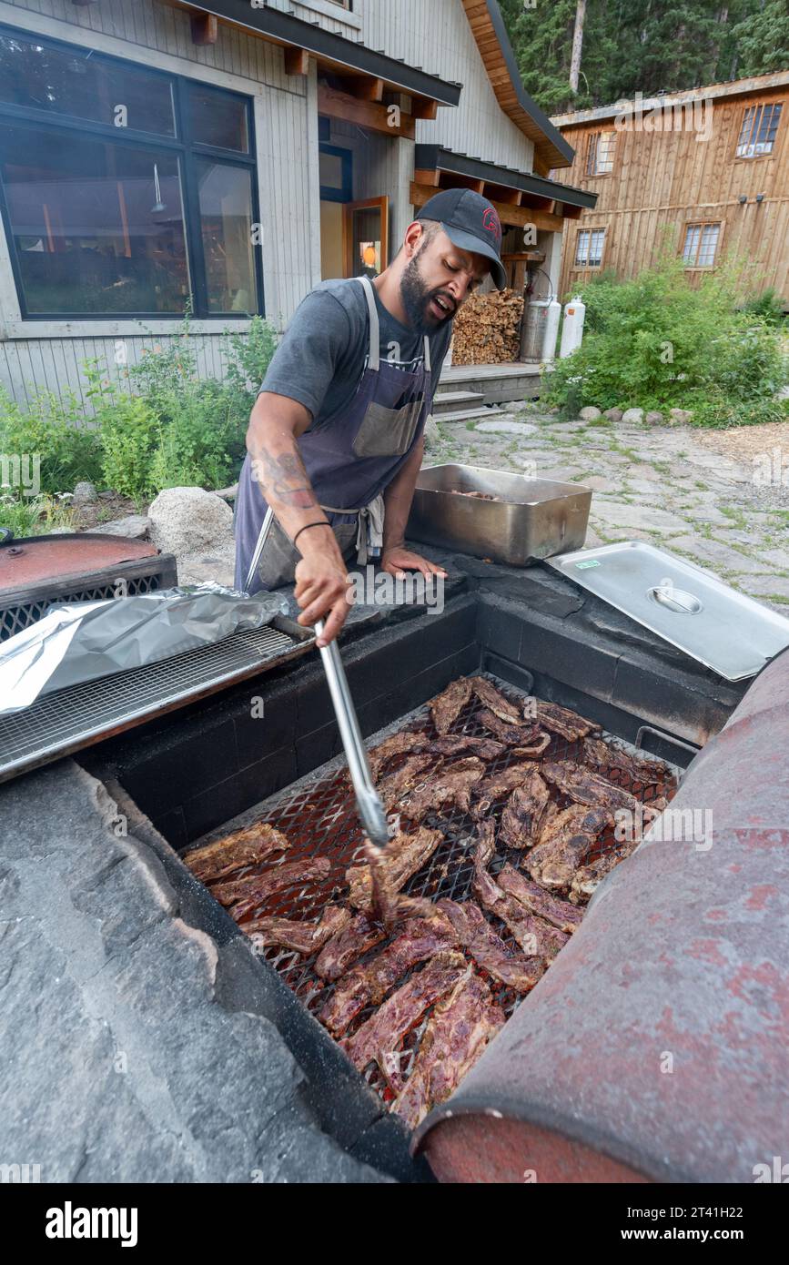Grilling short ribs on a wood fire grill at the Minam River Lodge ...